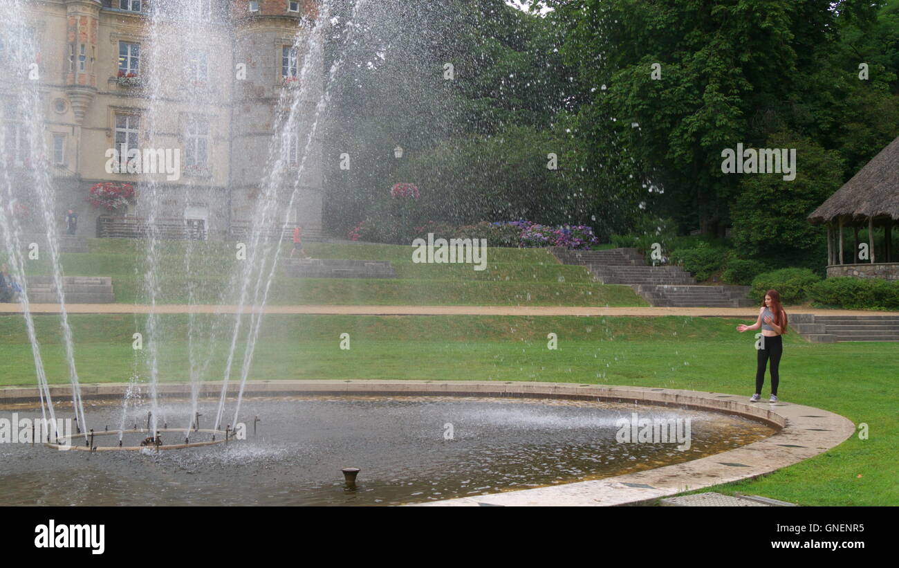 Young Girl Cooling Off In The Fountain At Bagnoles De LOrne Stock Photo ...