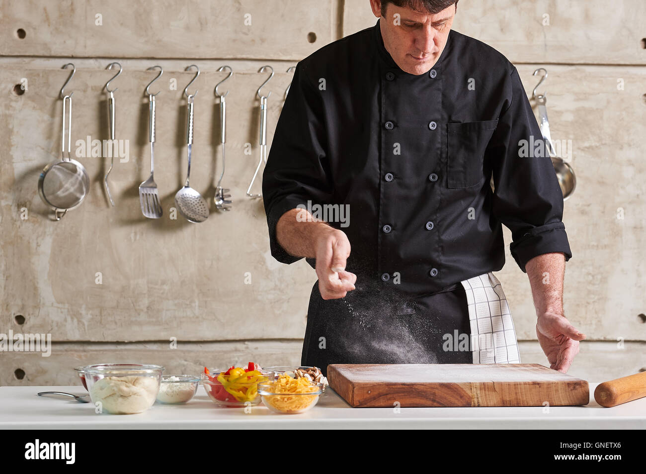 Restuarant hotel private chef dusting flour on board Stock Photo - Alamy