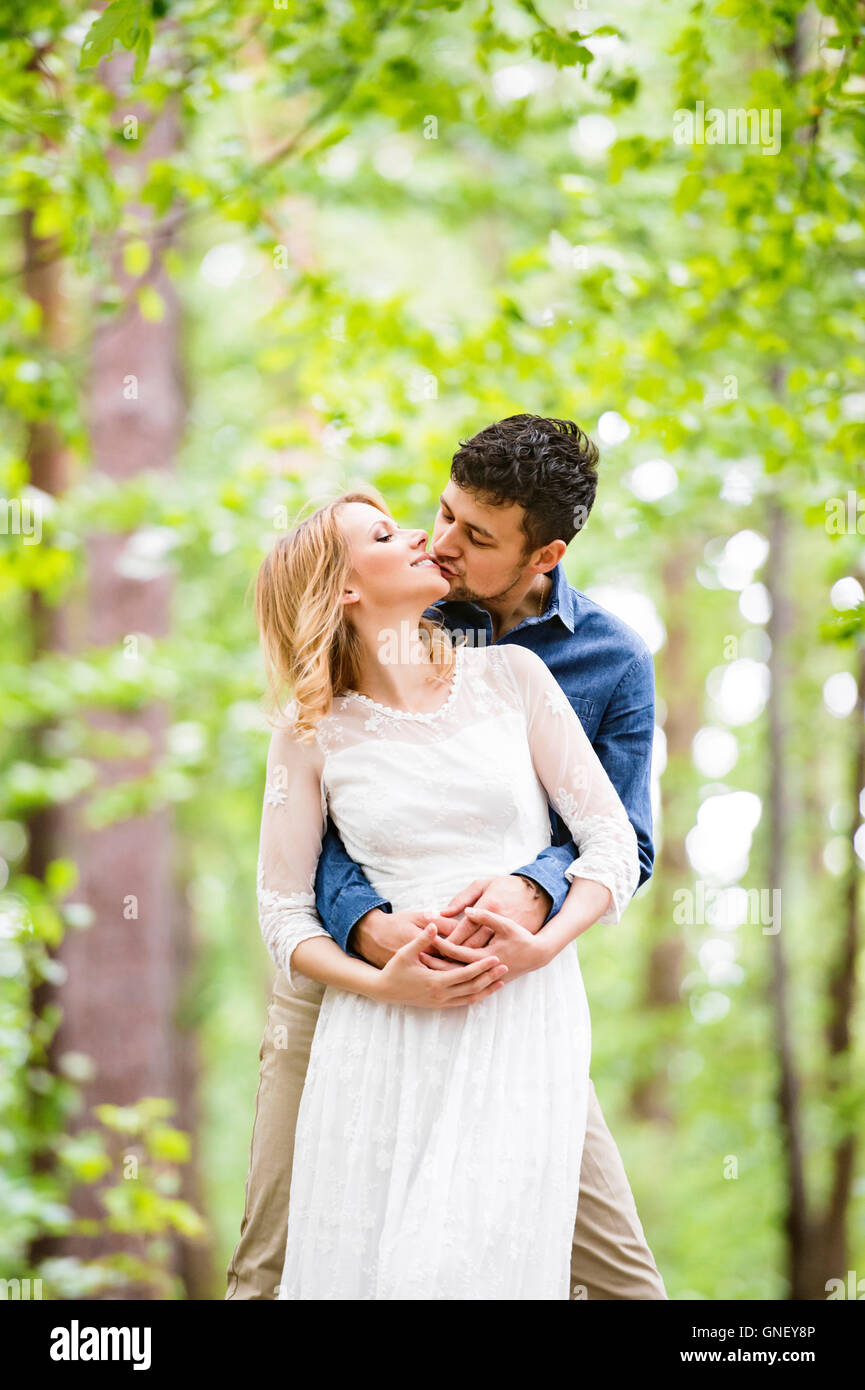 Beautiful wedding couple outside in green forest Stock Photo - Alamy