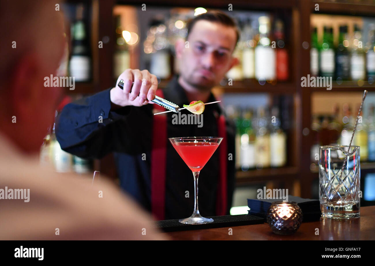 ILLUSTRATION - A barkeeper serves a guest a cocktail in the High-End ...