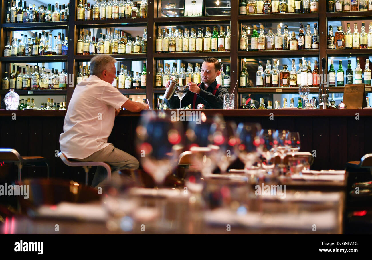 ILLUSTRATION - A barkeeper serves a guest a cocktail in the High-End ...