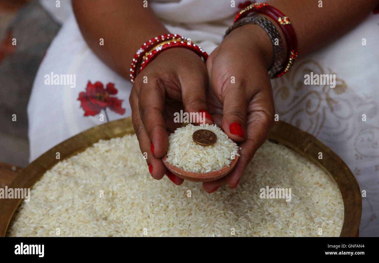 Kathmandu, Nepal. 30th Aug, 2016. A Buddhist distributes offerings to ...