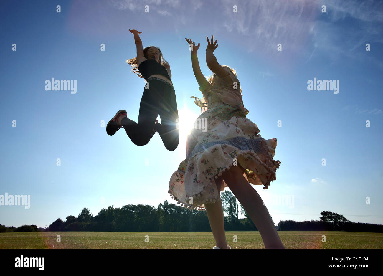 Children jumping in the sun Stock Photo - Alamy