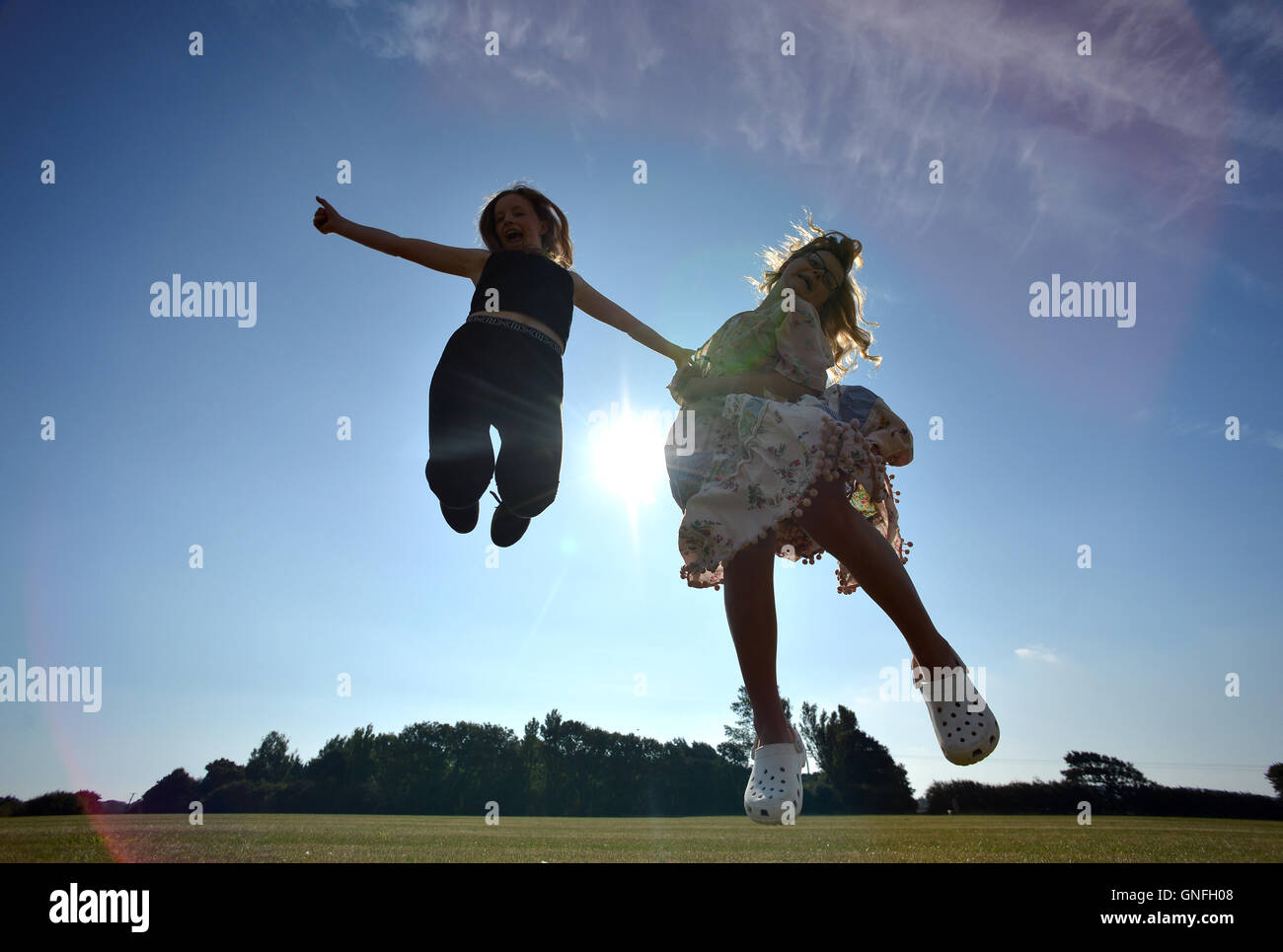 Children jumping in the sun Stock Photo - Alamy