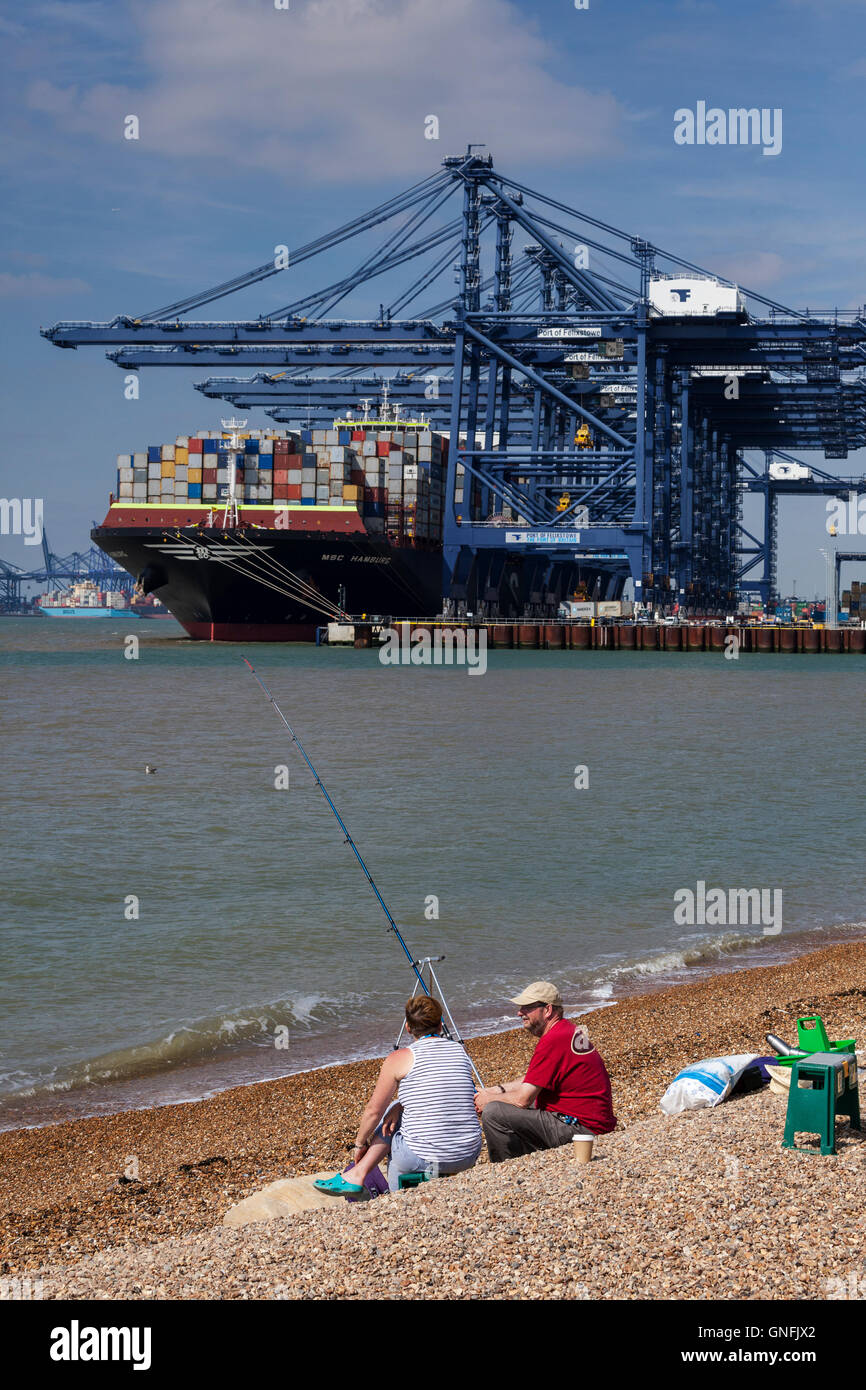 People on Beach Adjacent to Container Port with Ship Unloading in ...
