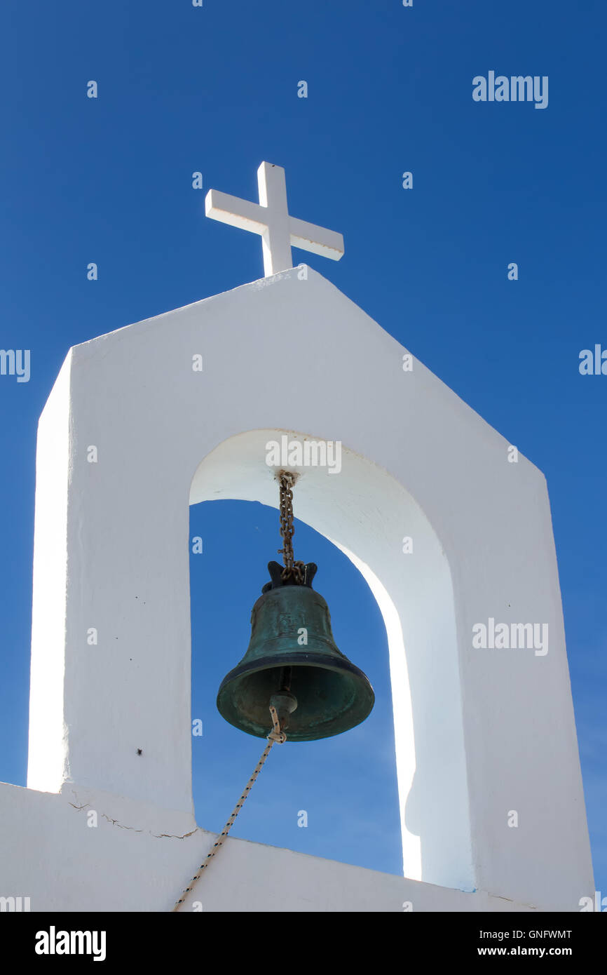 Detail of the architecture of a chapel in Greece. Heavy bell with a ...
