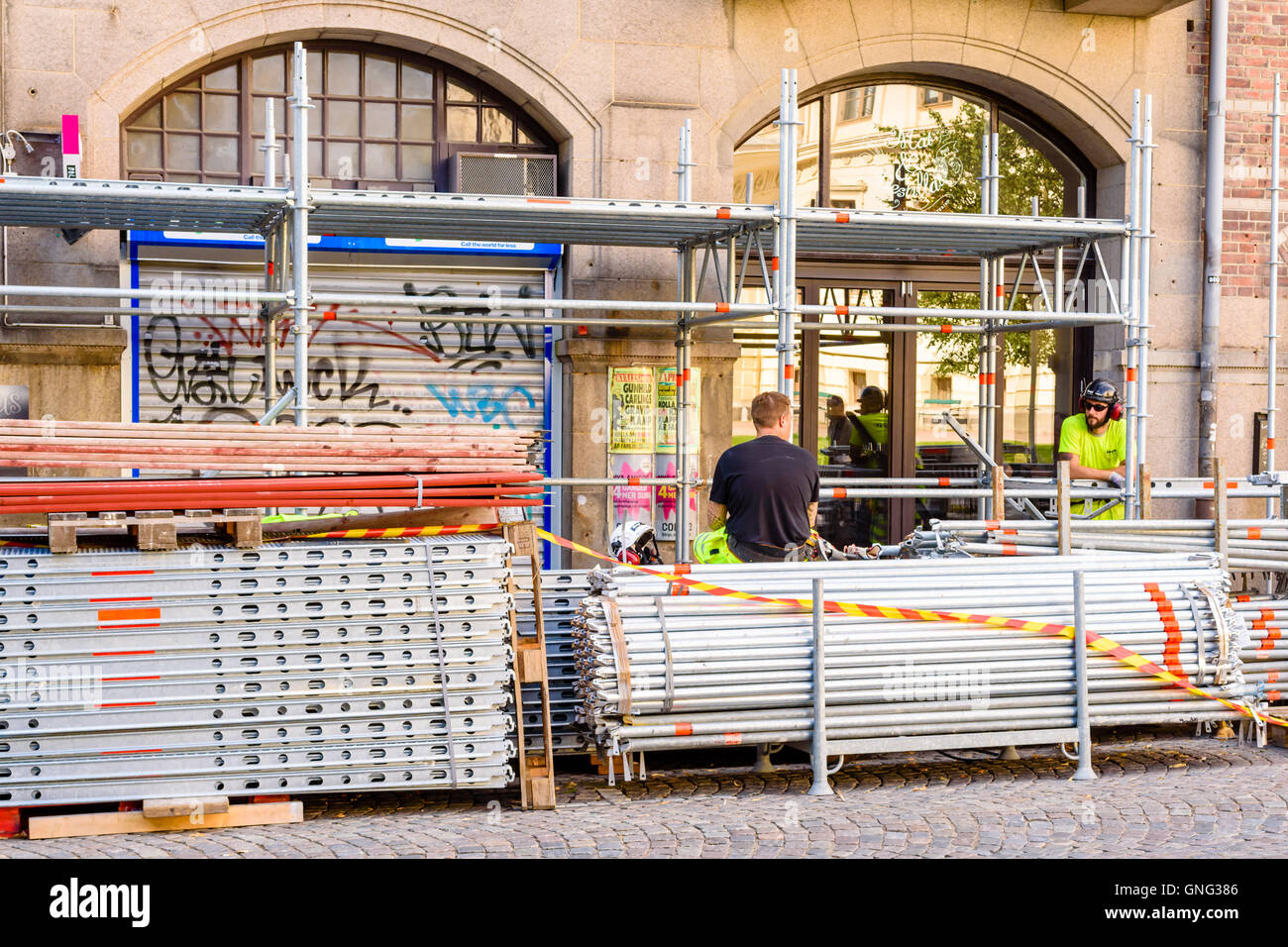 Lund, Sweden - August 24, 2016: Two male scaffolding builders taking a ...