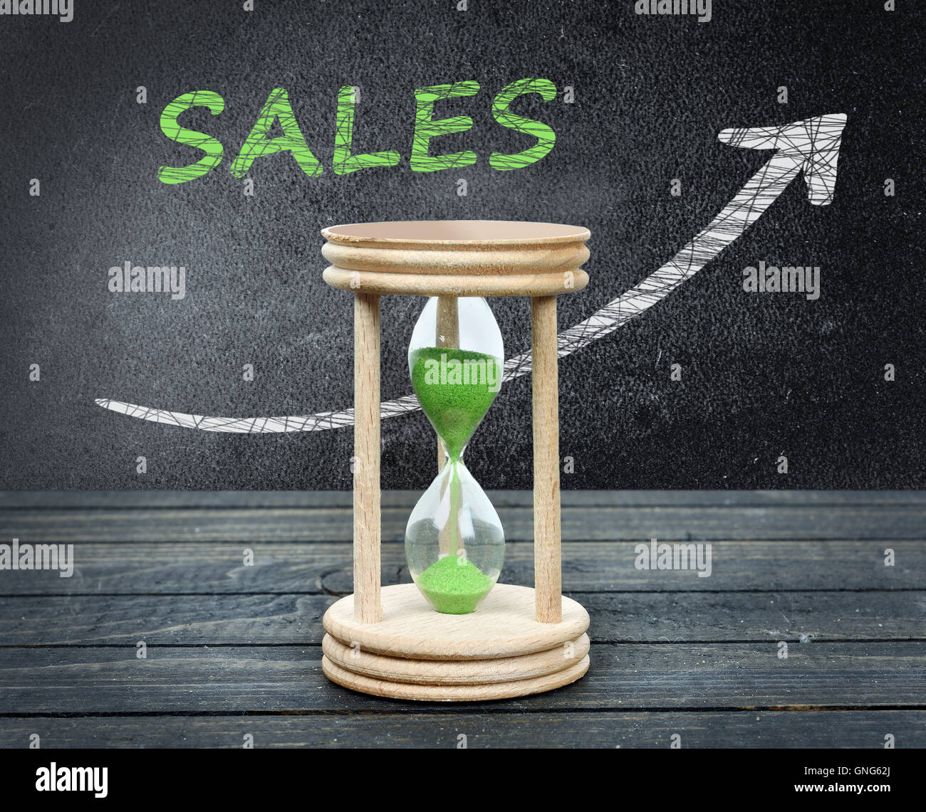 Sales and hourglass close-up on wooden table Stock Photo - Alamy