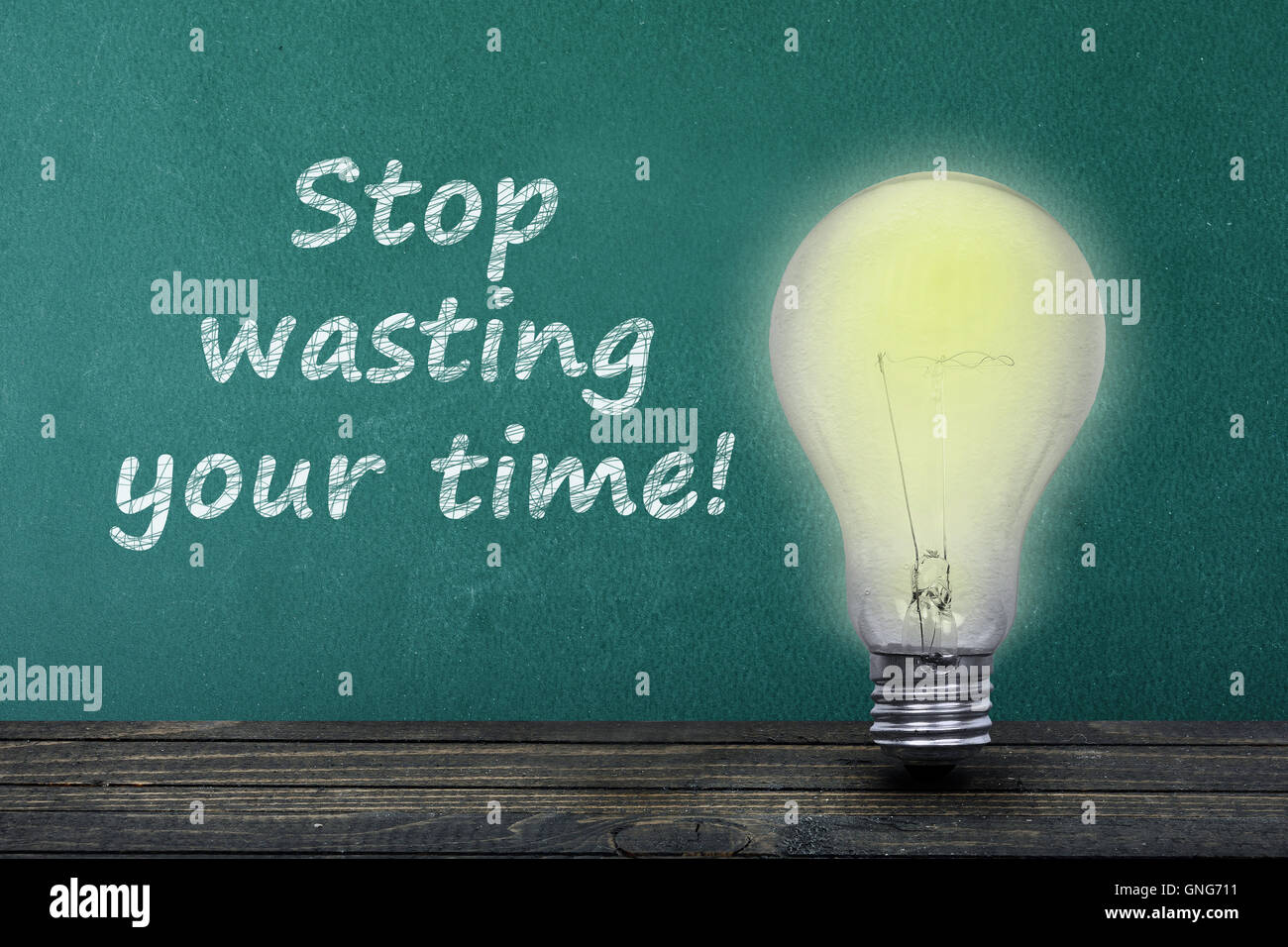 Stop wasting your text on green board and light bulb on table Stock ...