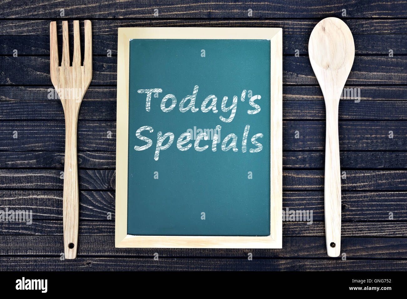 Today's Specials text on green board with fork and spoon on wooden ...