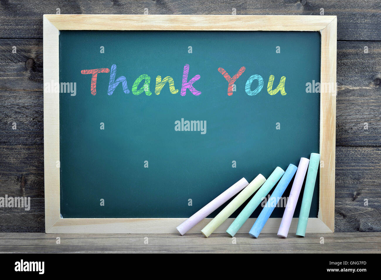 Thank you text on school board and chalk on wooden table Stock Photo ...
