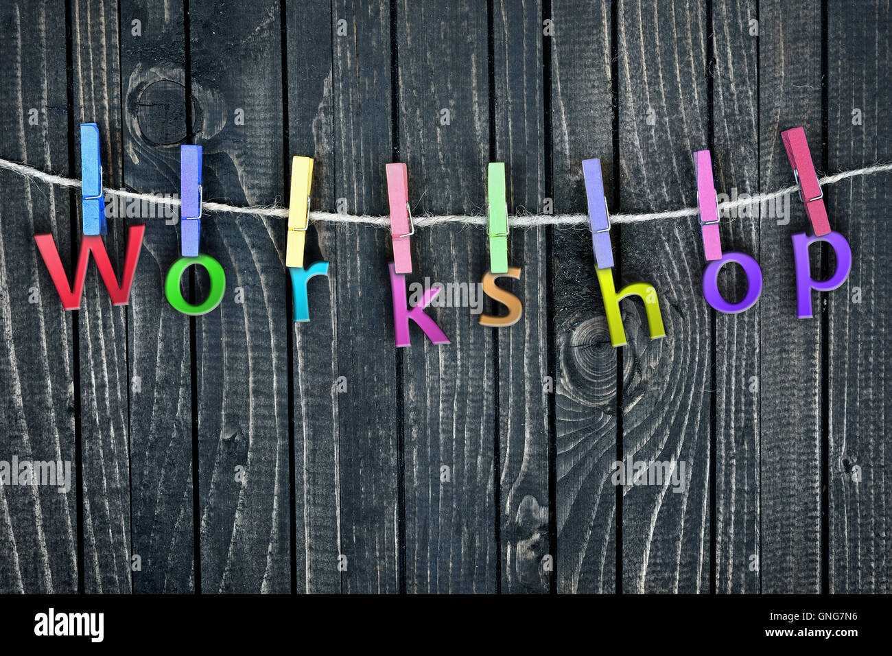 Workshop word hanging on clips and wooden wall Stock Photo - Alamy