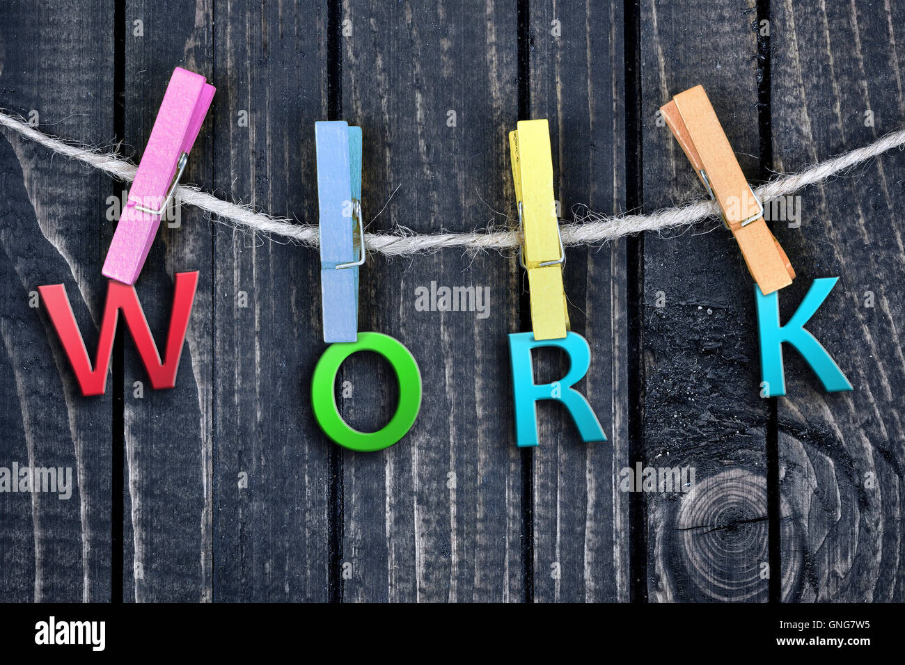 Work word hanging on clips and wooden wall Stock Photo - Alamy
