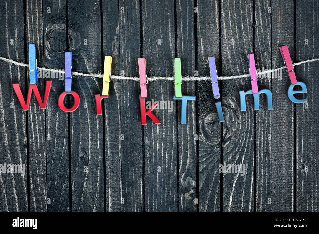 Work Time word hanging on clips and wooden wall Stock Photo - Alamy