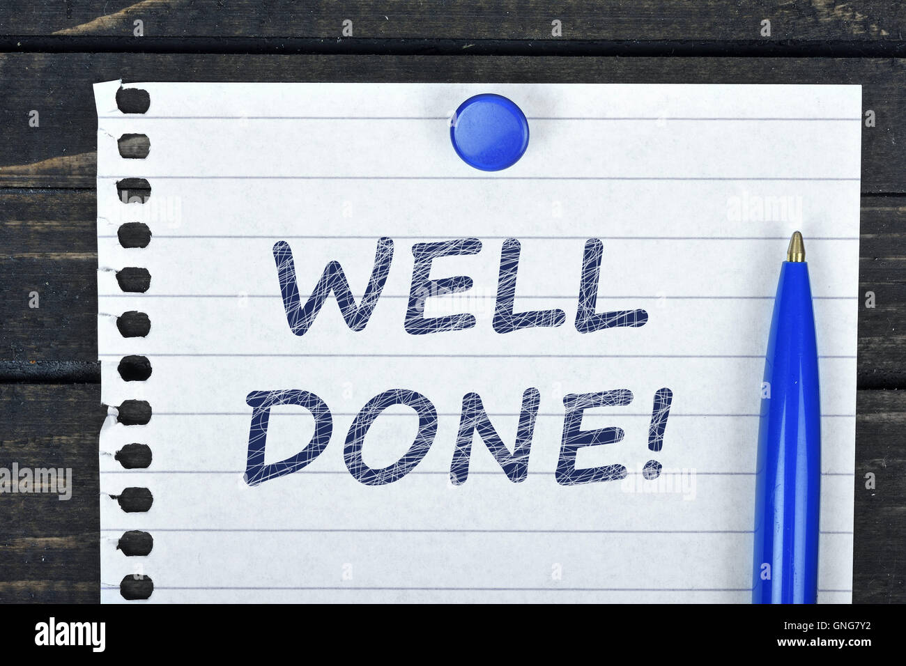 Well Done text on page and pen on wooden table Stock Photo - Alamy