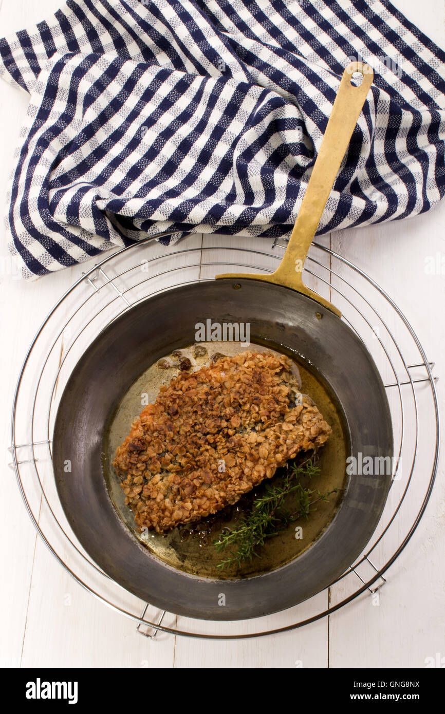 grilled scottish kipper coated with organic oatmeal and thyme in a pan ...