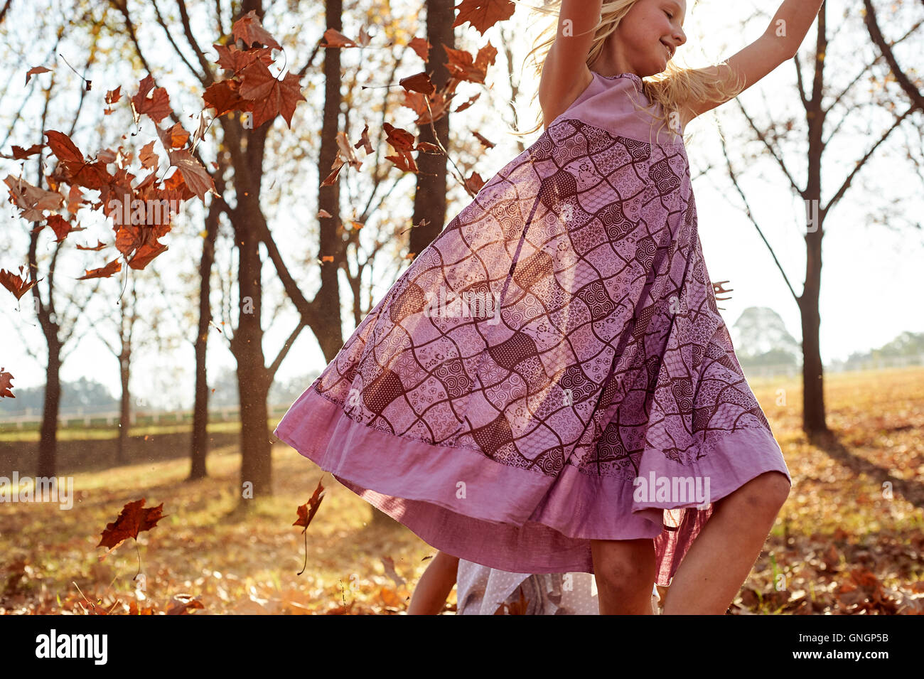 Young girls children kids playing running in fallen autumn leaves Stock ...