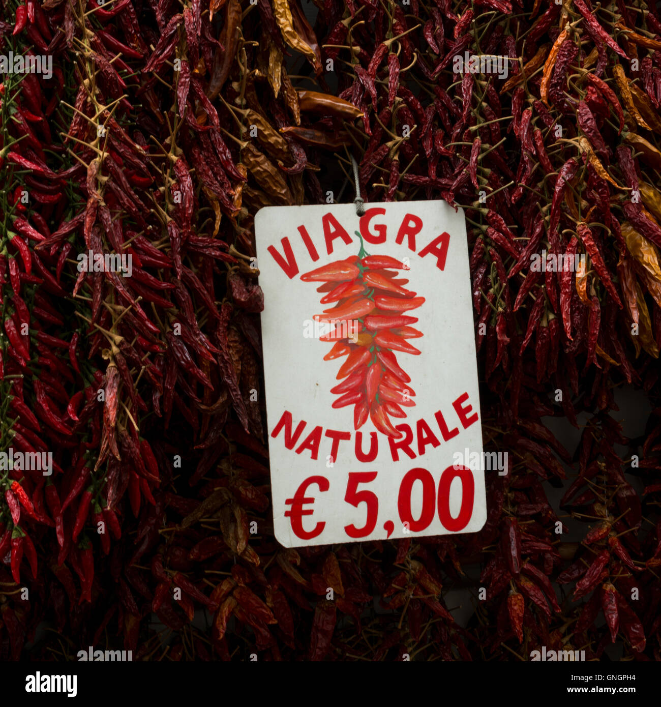 Dry red chili peppers hanging with price tag at market stall, Amalfi ...