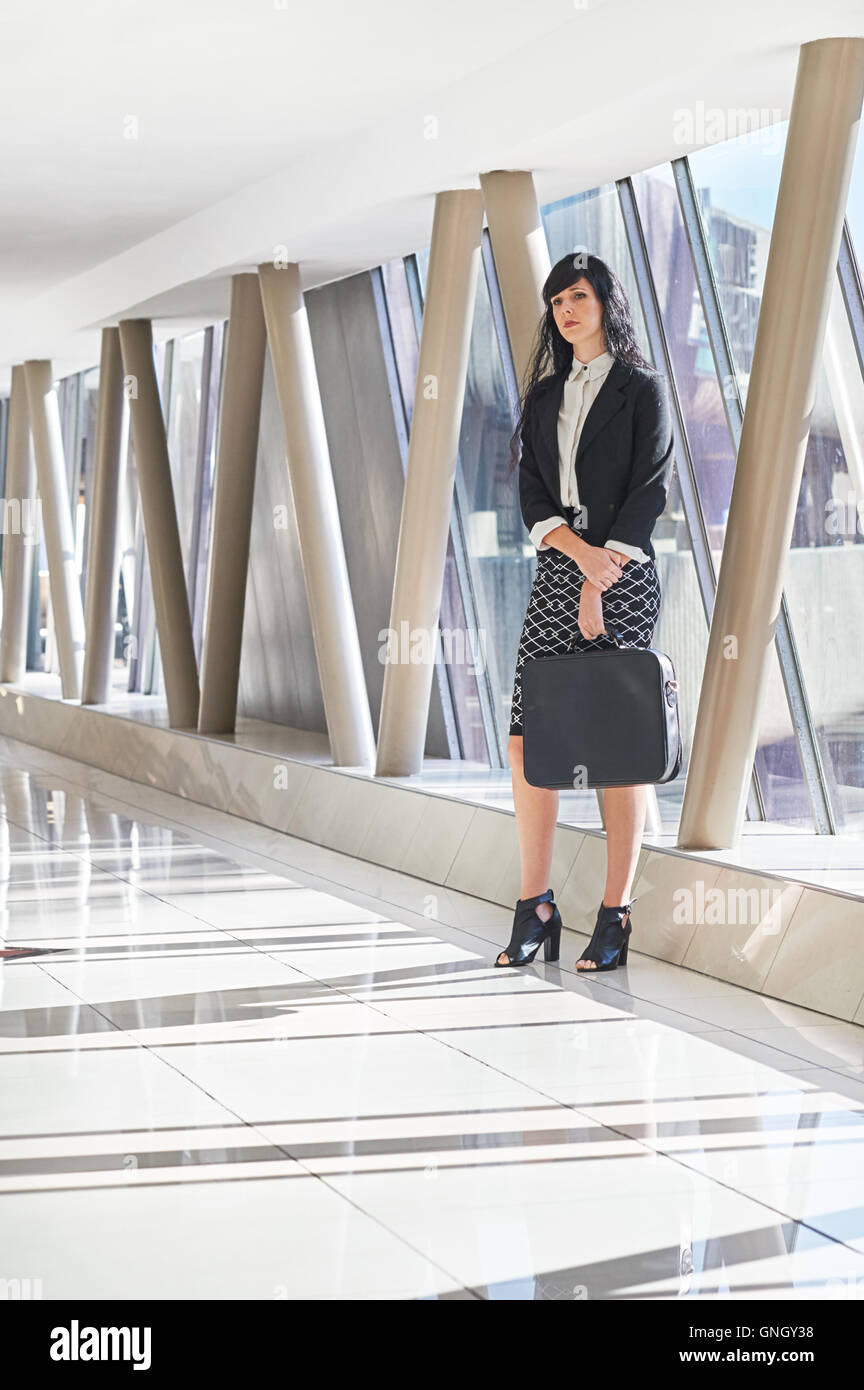 Young attractive female business woman waiting in hallway Stock Photo ...