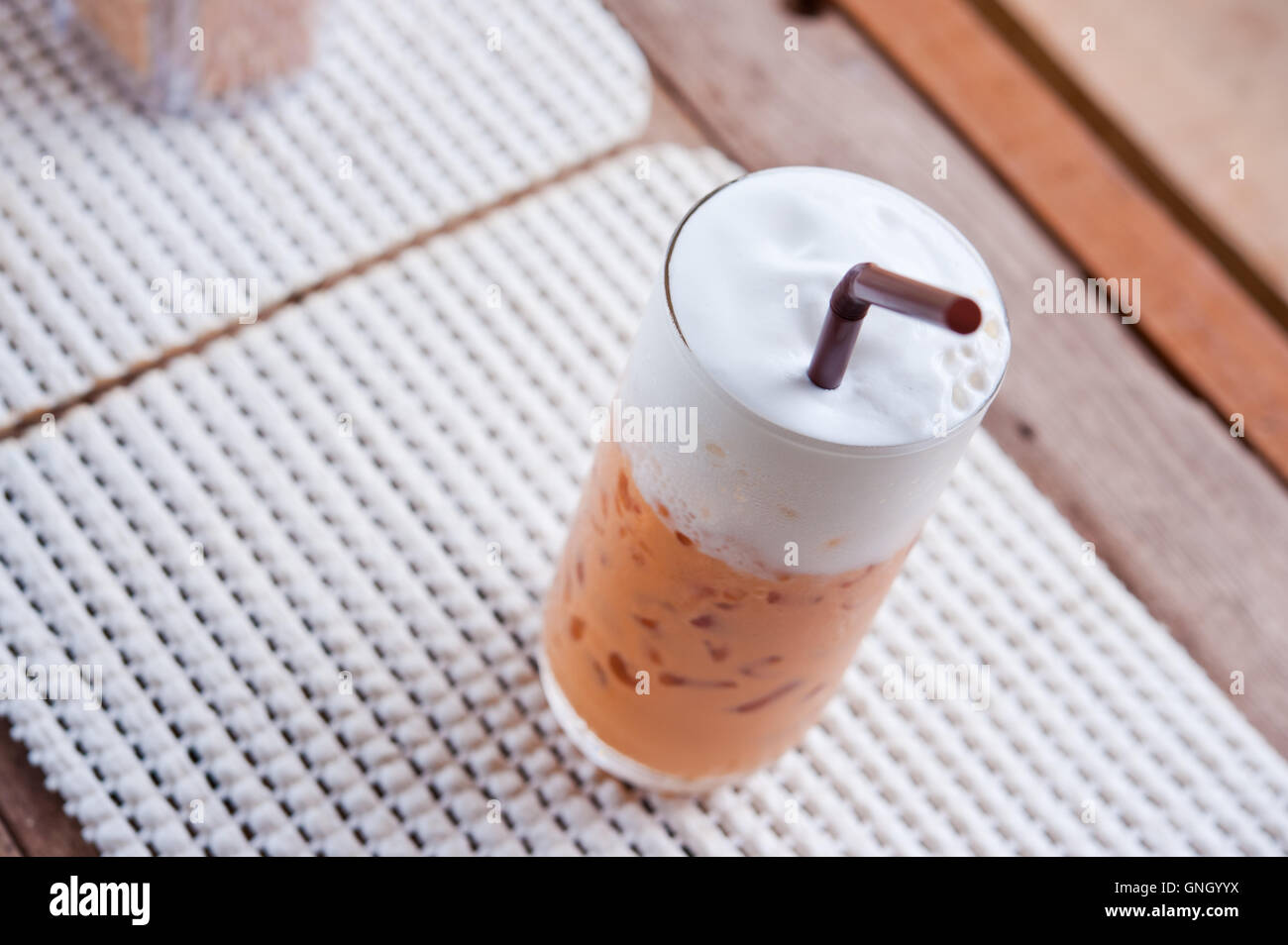 Iced thai milk tea with milk foam Stock Photo - Alamy