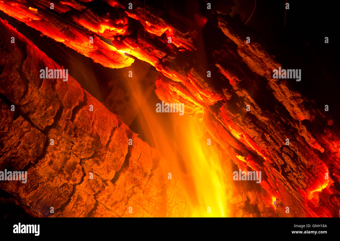 Burning log with flames and glowing embers Stock Photo - Alamy