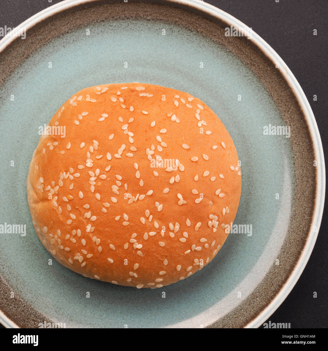 Hamburger bun on a rustic plate top view Stock Photo - Alamy
