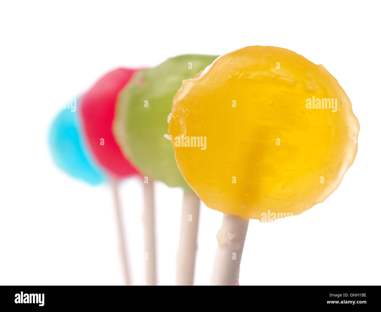 Four colorful lollipop in a row on a white background Stock Photo - Alamy