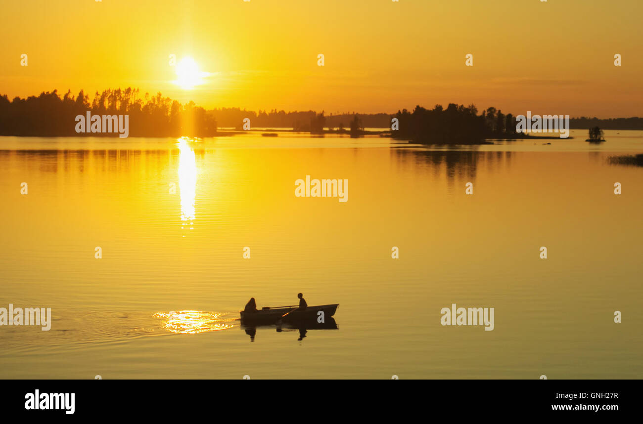Silhouette of a couple in a rowing boat at sunset, Russia Stock Photo ...