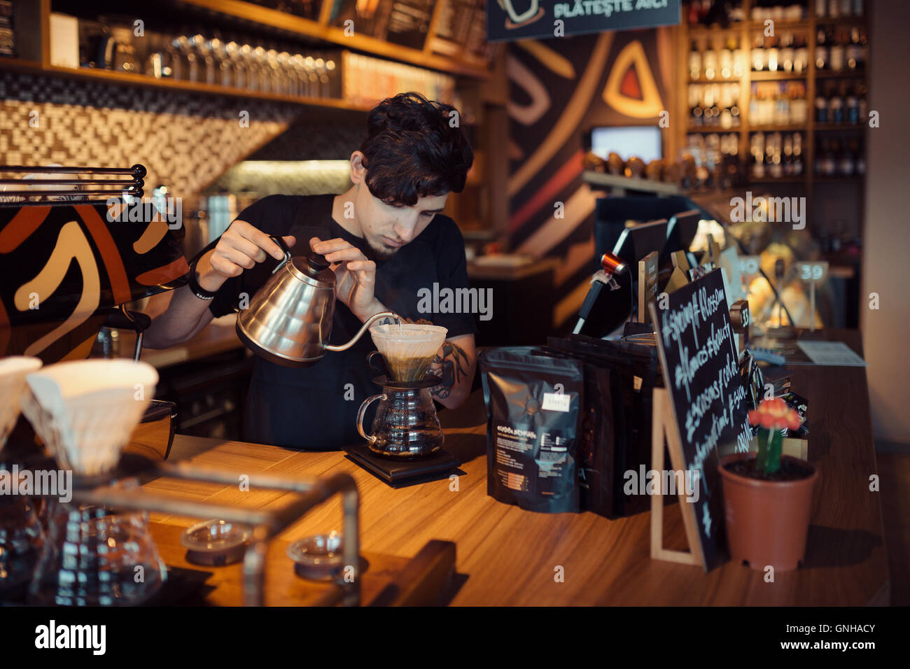 Barista at work in a coffee shop Stock Photo - Alamy