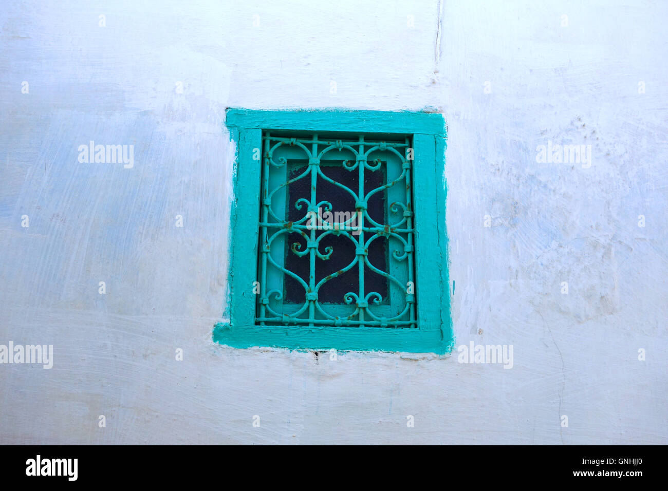Decorative teal blue window on a white wall in Alsirah, Morocco Stock ...
