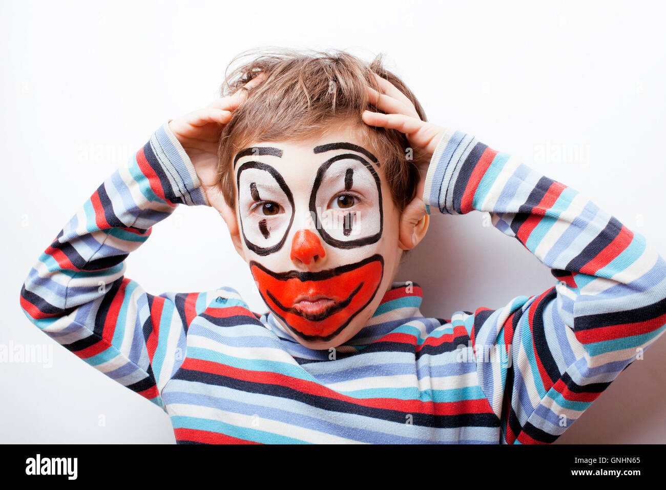 little cute boy with facepaint like clown, pantomimic expressions close ...