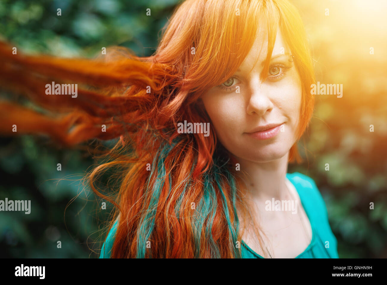 Young trendy woman with colored bright red head having fun outdoors ...