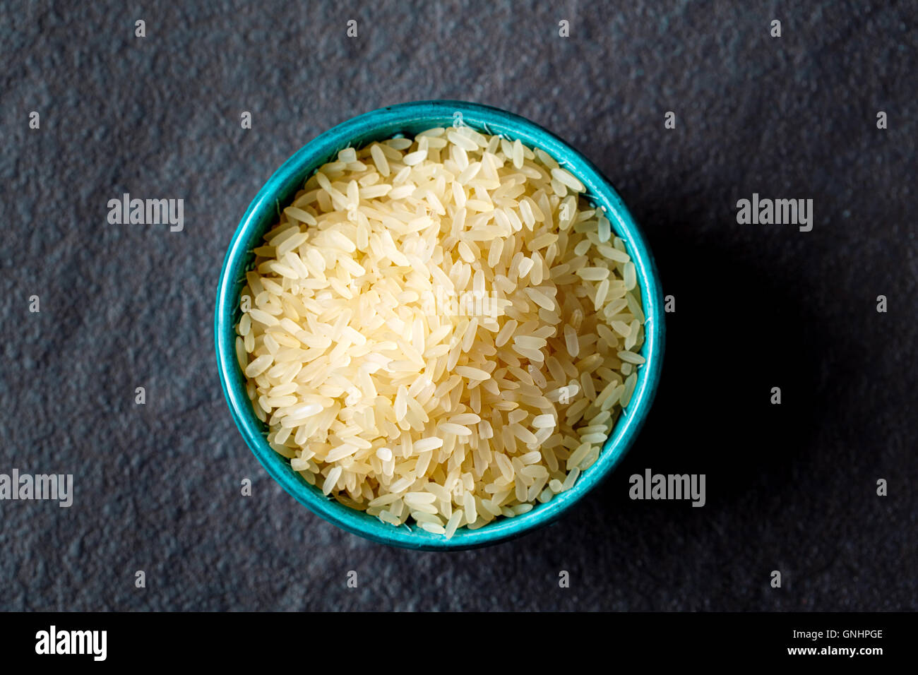 Food background, rice close-up in ethnic bowl on dark surface, top view ...
