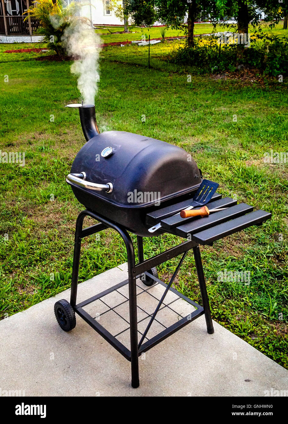 Garden smoker BBQ puffing out smoke Stock Photo - Alamy
