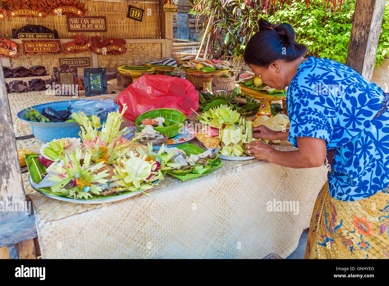 UBUD, INDONESIA - AUGUST 29, 2008: Woman preparing traditional sacred ...