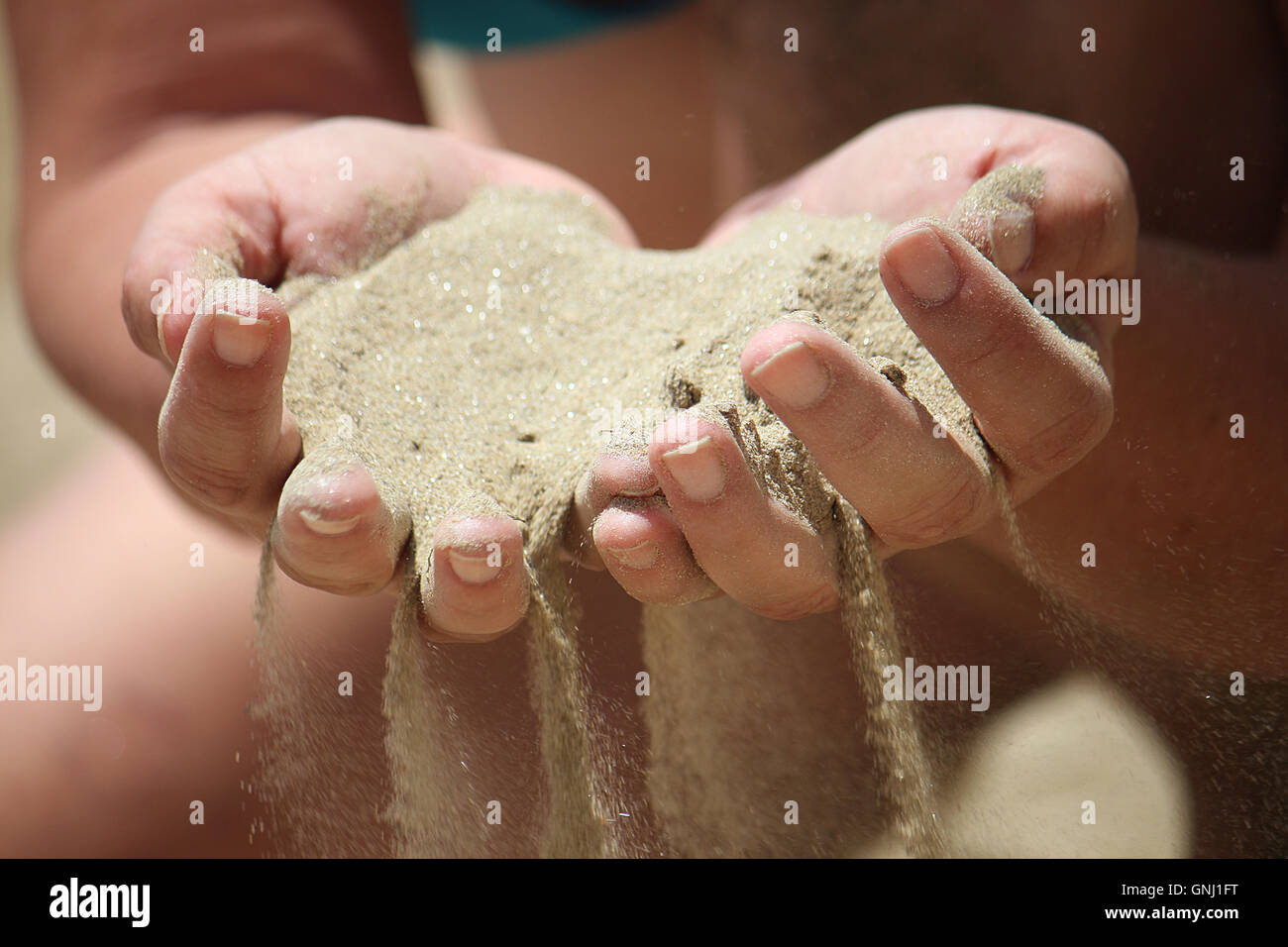 Hands holding pouring sand hi-res stock photography and images - Alamy