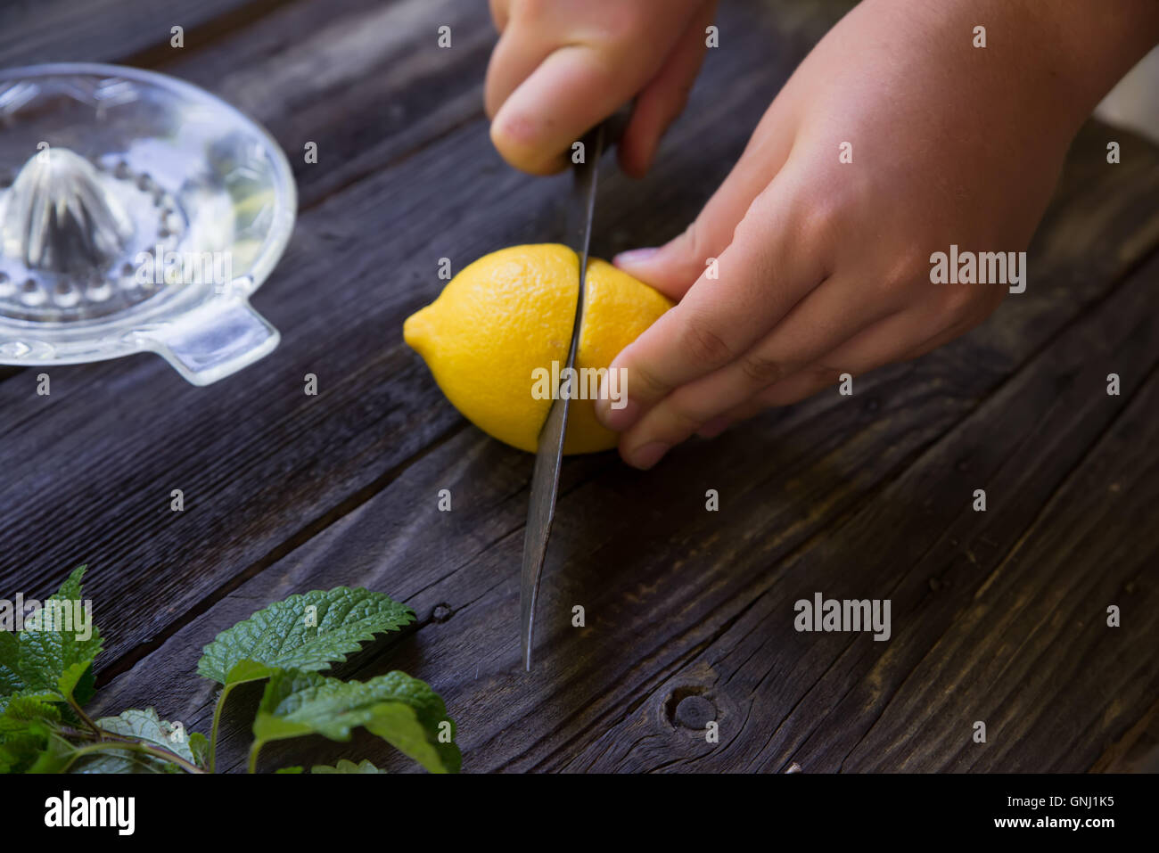 Boy cutting lemon Stock Photo - Alamy