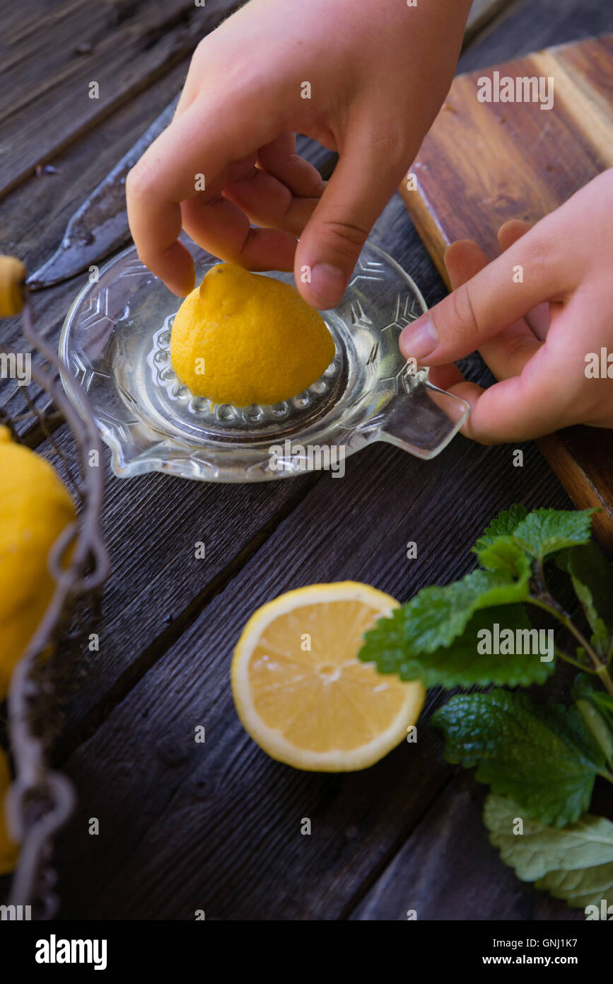 Boy cutting lemon Stock Photo - Alamy