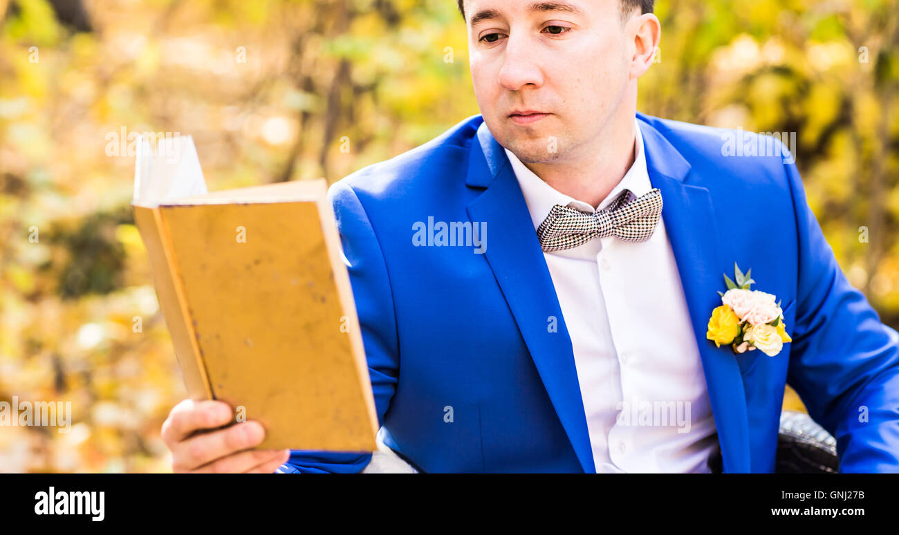 Man reading book in nature Stock Photo - Alamy