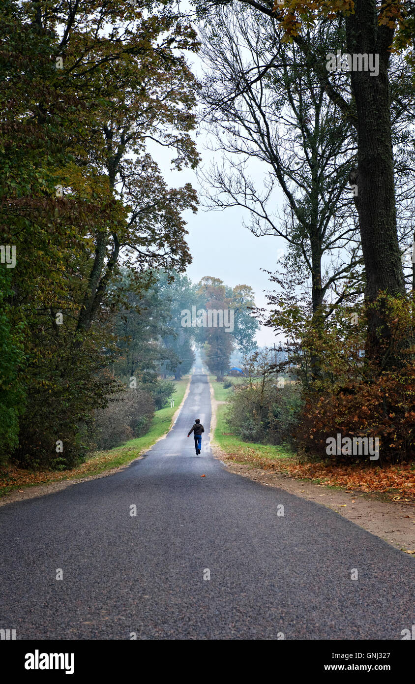 Man running down road, Lithuania Stock Photo - Alamy
