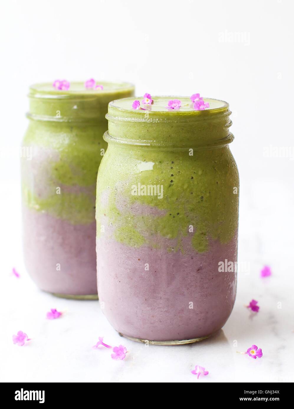Two Green and Purple fruit and vegetable Smoothie drinks with flower ...