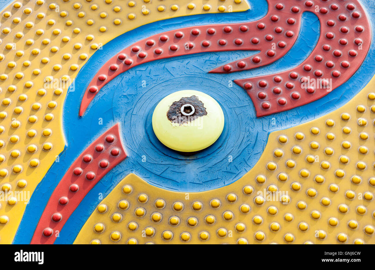 Closeup of the colorful circle toy in the playground of the city park ...