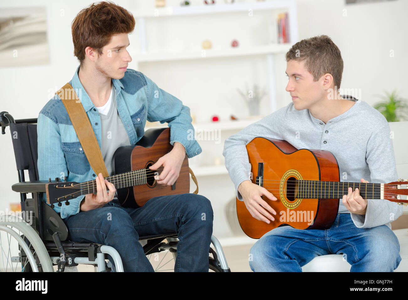 Playing the guitar together Stock Photo - Alamy