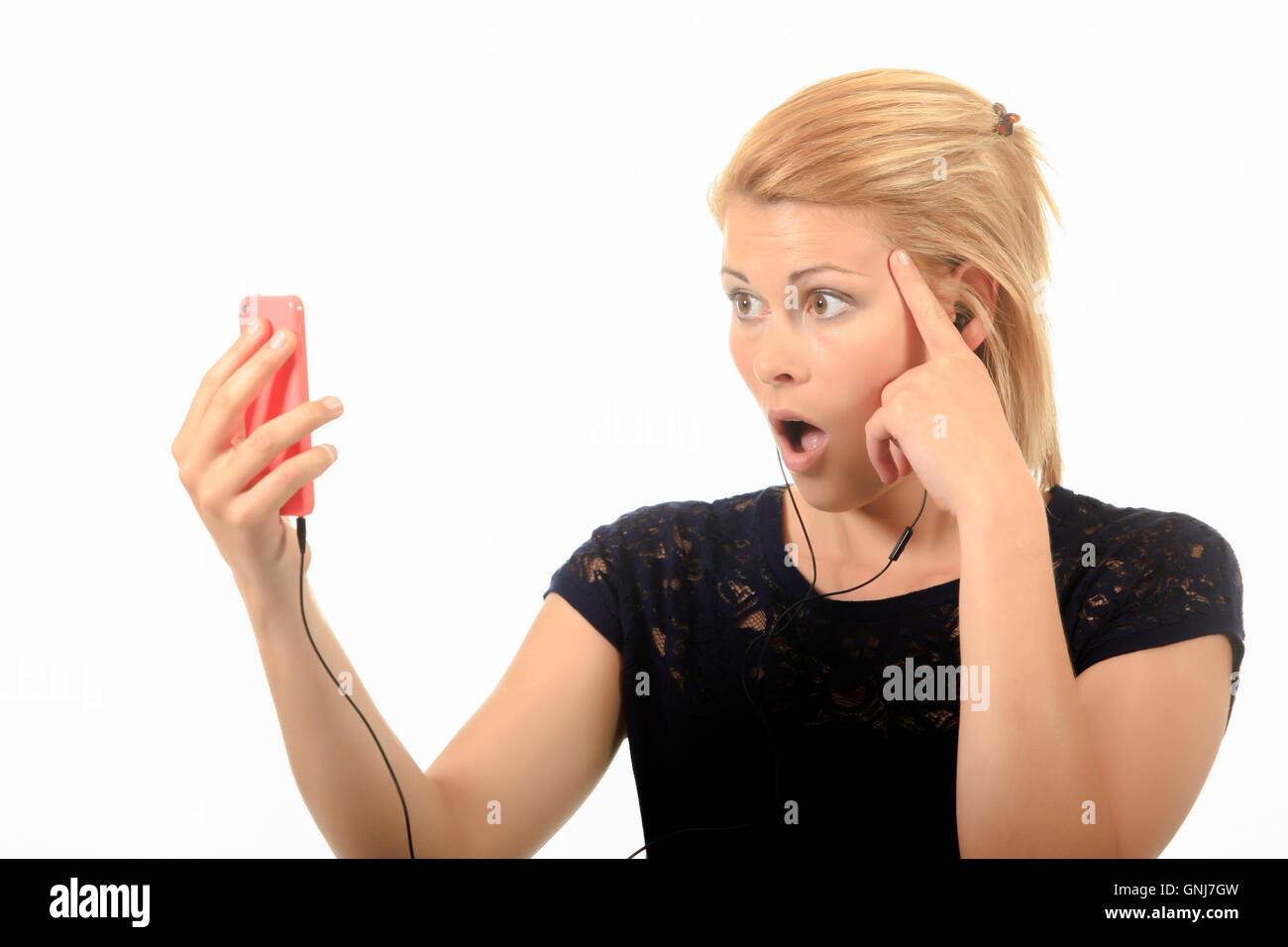 Woman shocked by a text message Stock Photo - Alamy