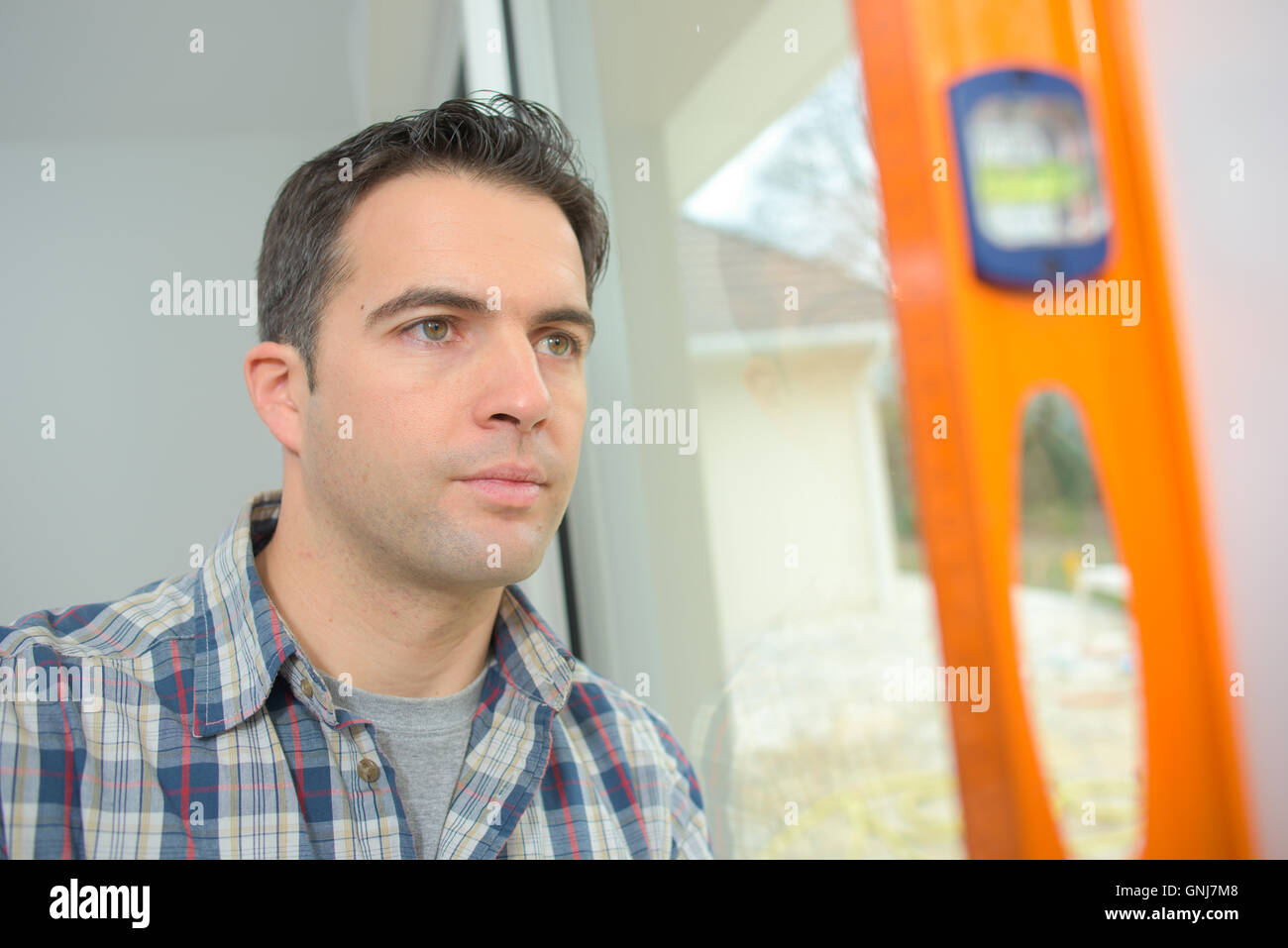 Checking the wall is straight Stock Photo - Alamy
