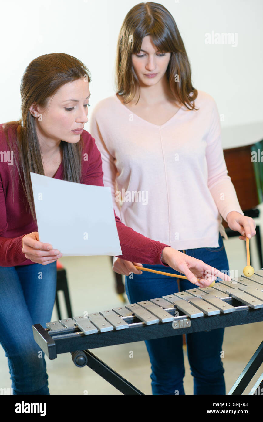 Woman being taught the xylophone Stock Photo - Alamy
