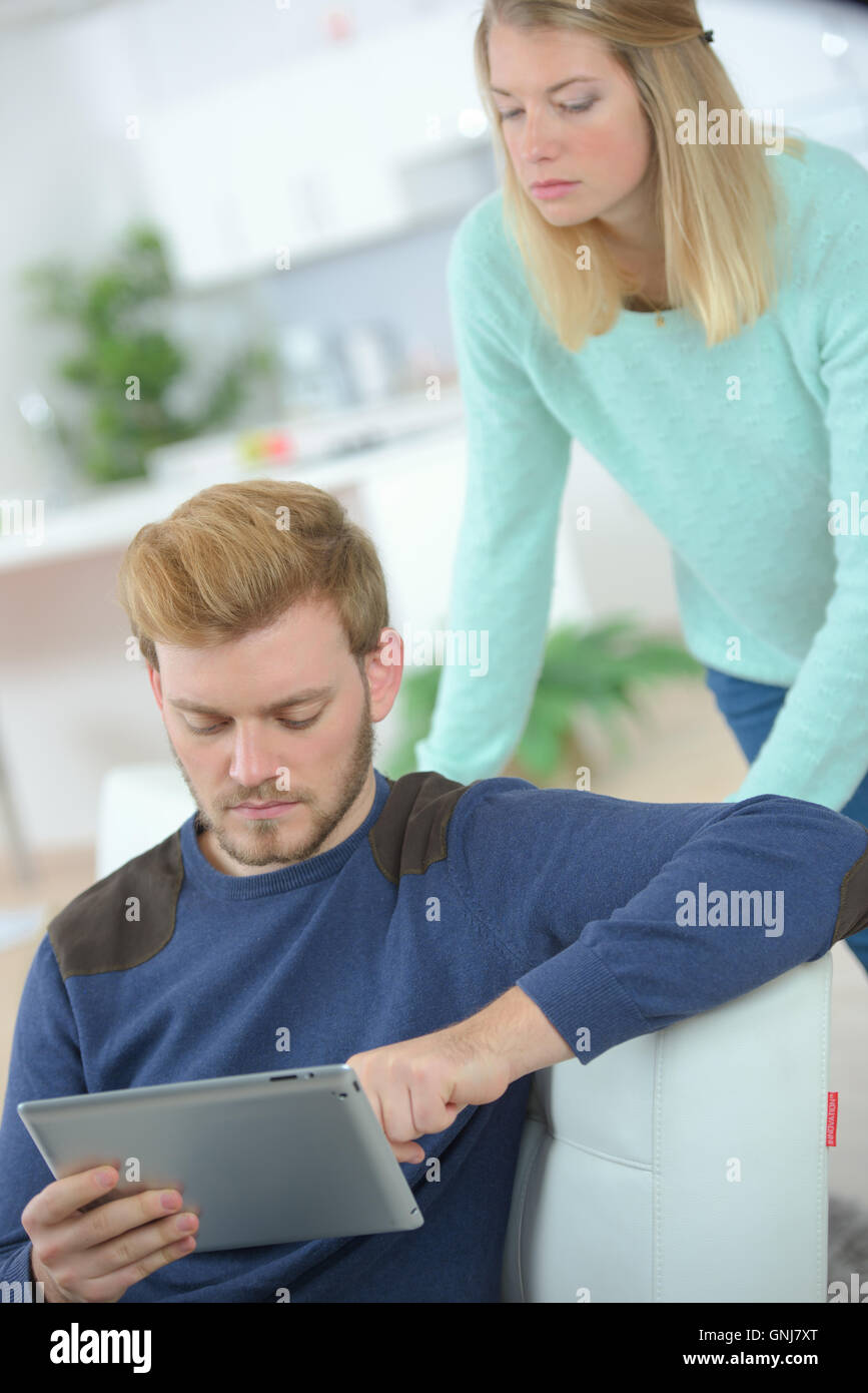 Making use of their tablet computer Stock Photo - Alamy