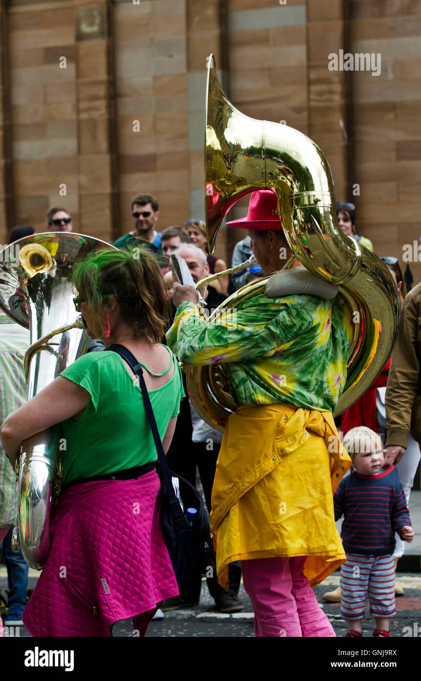 Man and woman playing tuba and sousaphone in a horns band taking part ...