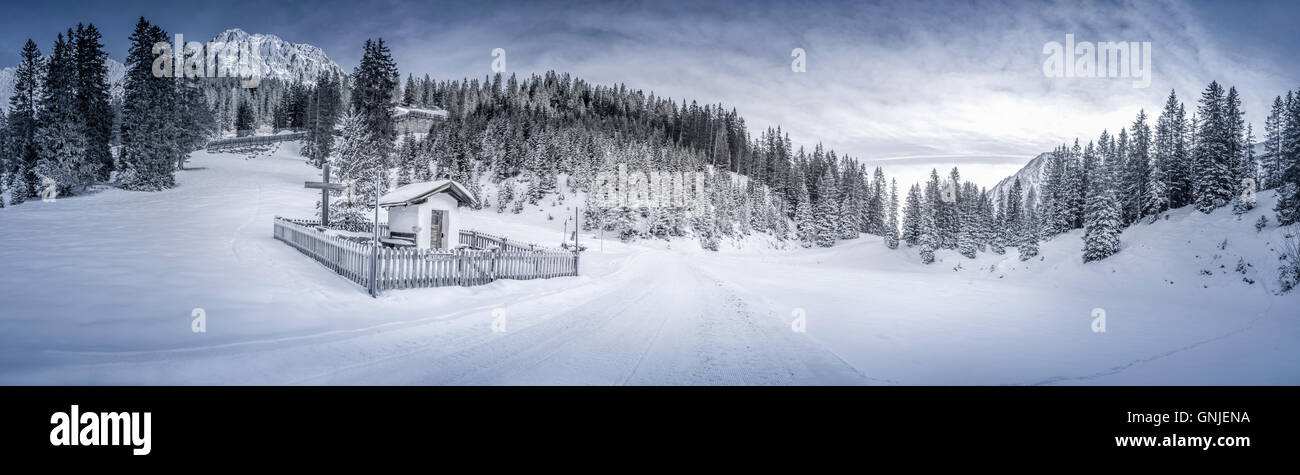 Winter scenery with snowy forest and chapel Stock Photo - Alamy