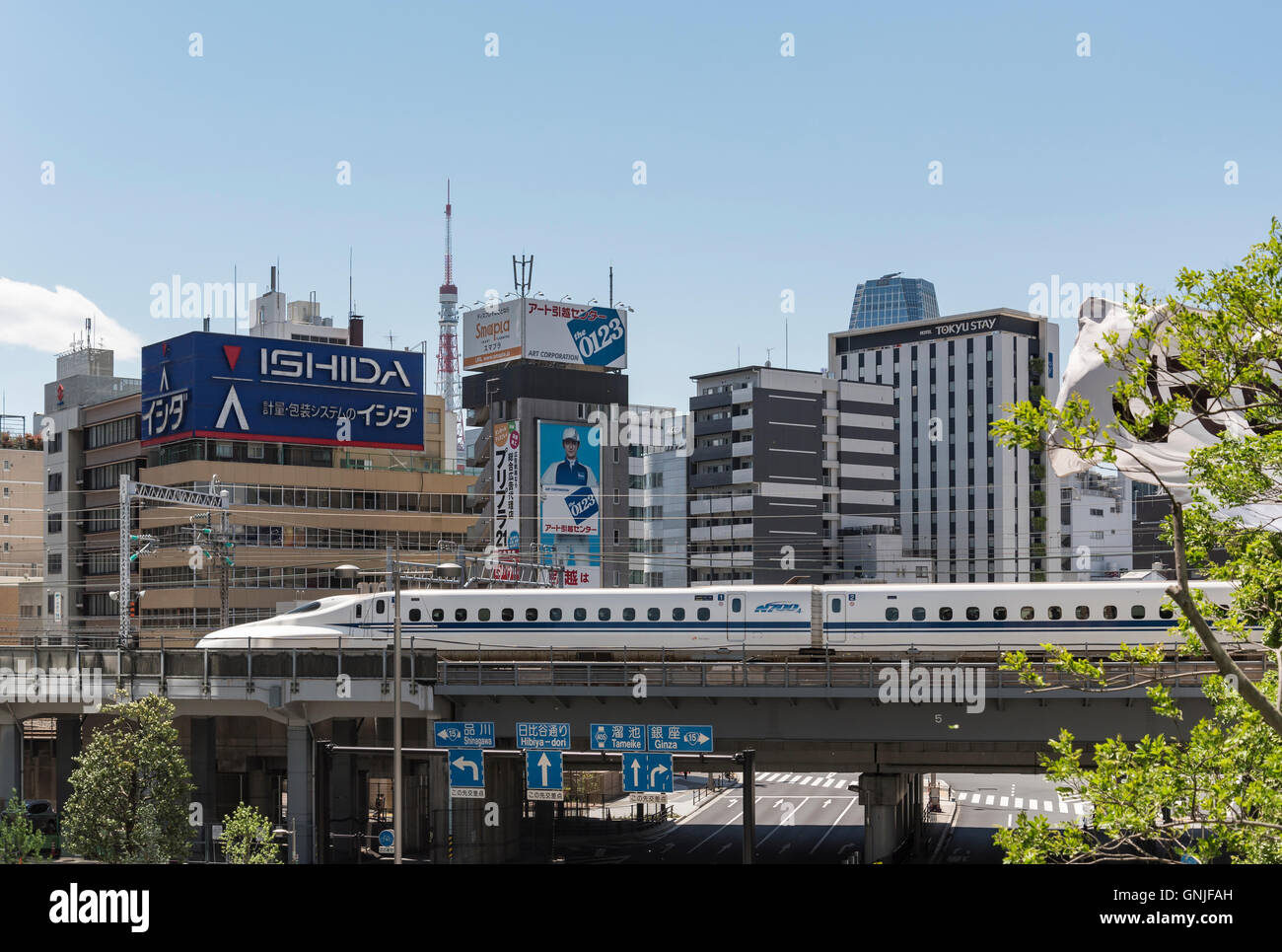Shinkansen bullet train on a bridge in Shiodome area in Minato, Tokyo ...